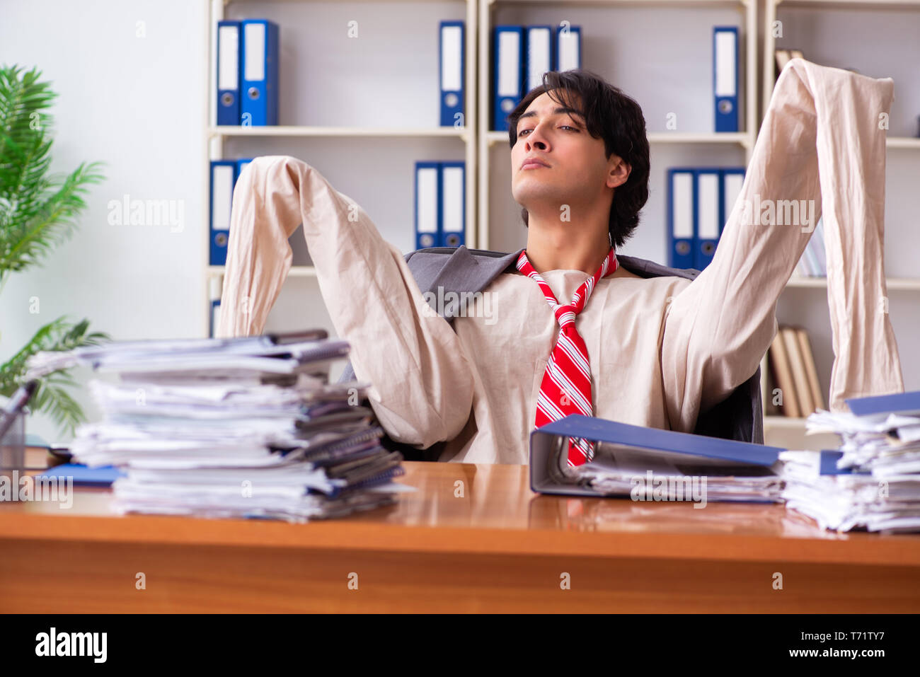 Crazy young man in straitjacket at the office Stock Photo - Alamy