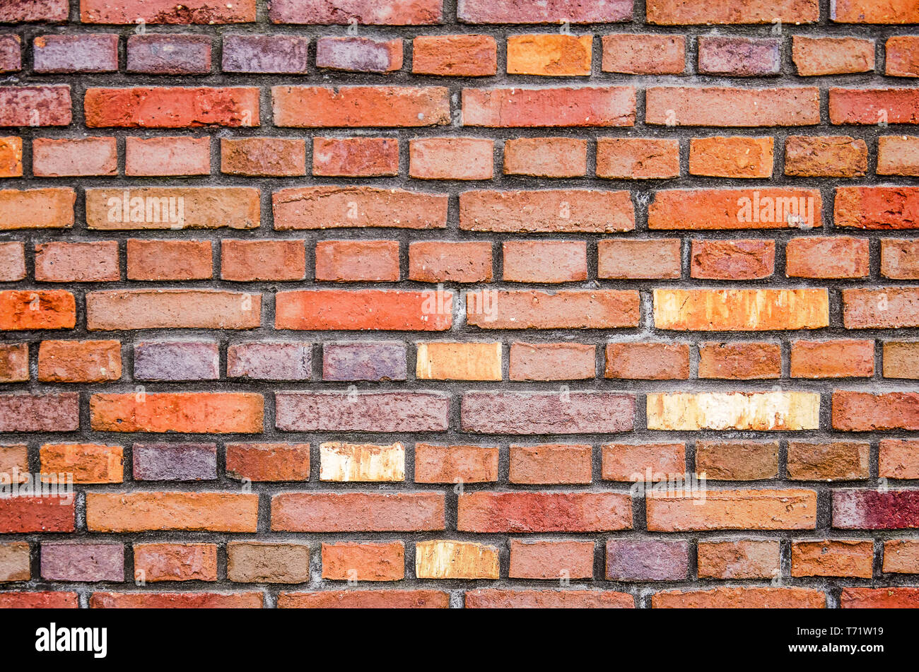 Recently built masonry wall with deep joints and a colorful blend of ...