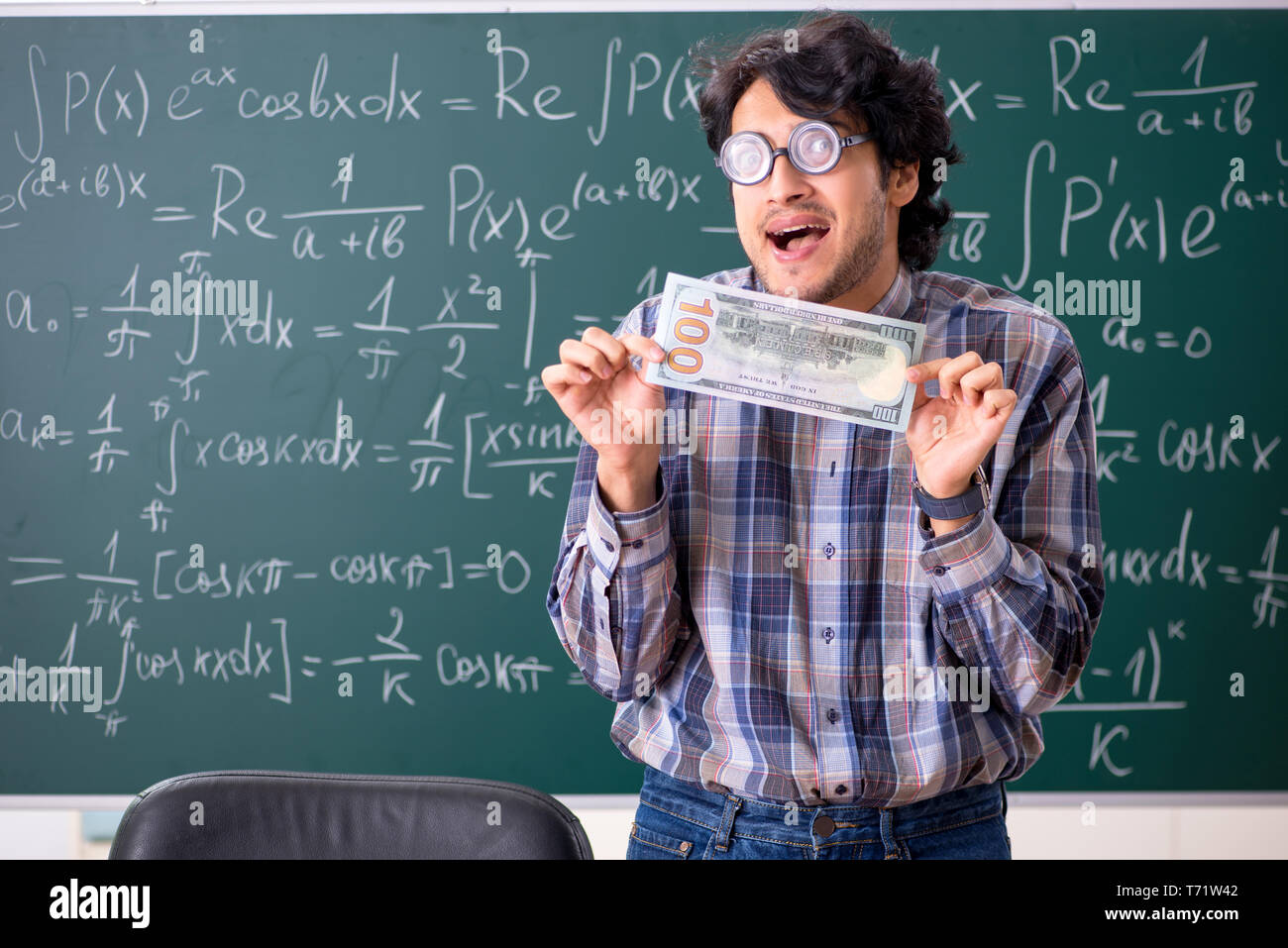 Funny male math teacher in the classroom Stock Photo - Alamy