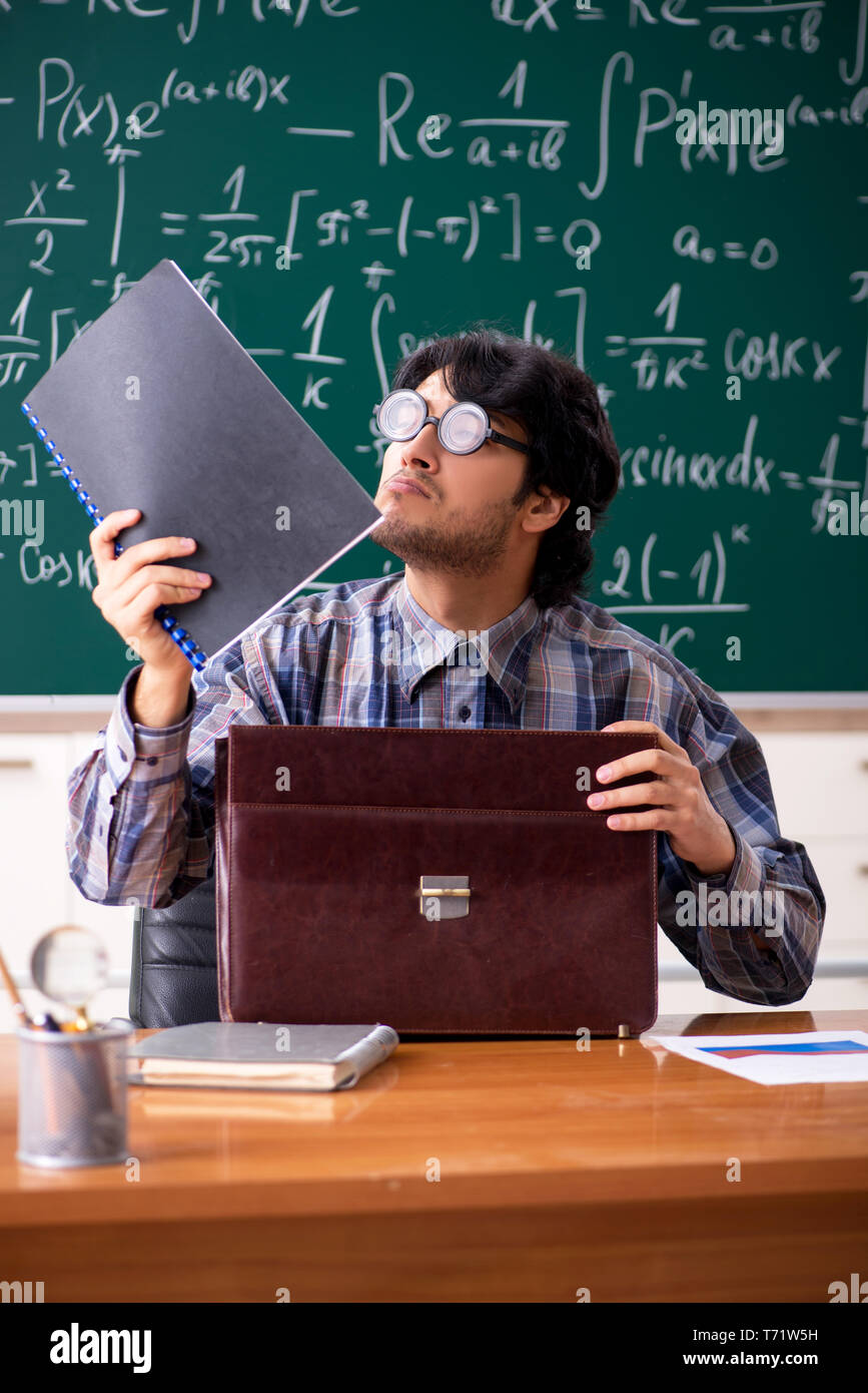 Funny male math teacher in the classroom Stock Photo - Alamy