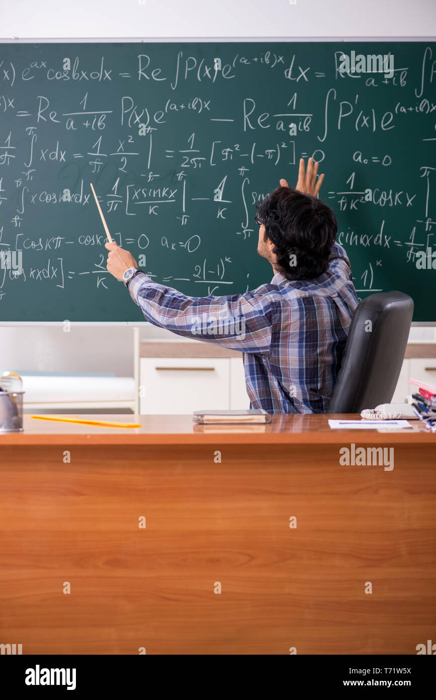 Funny male math teacher in the classroom Stock Photo - Alamy
