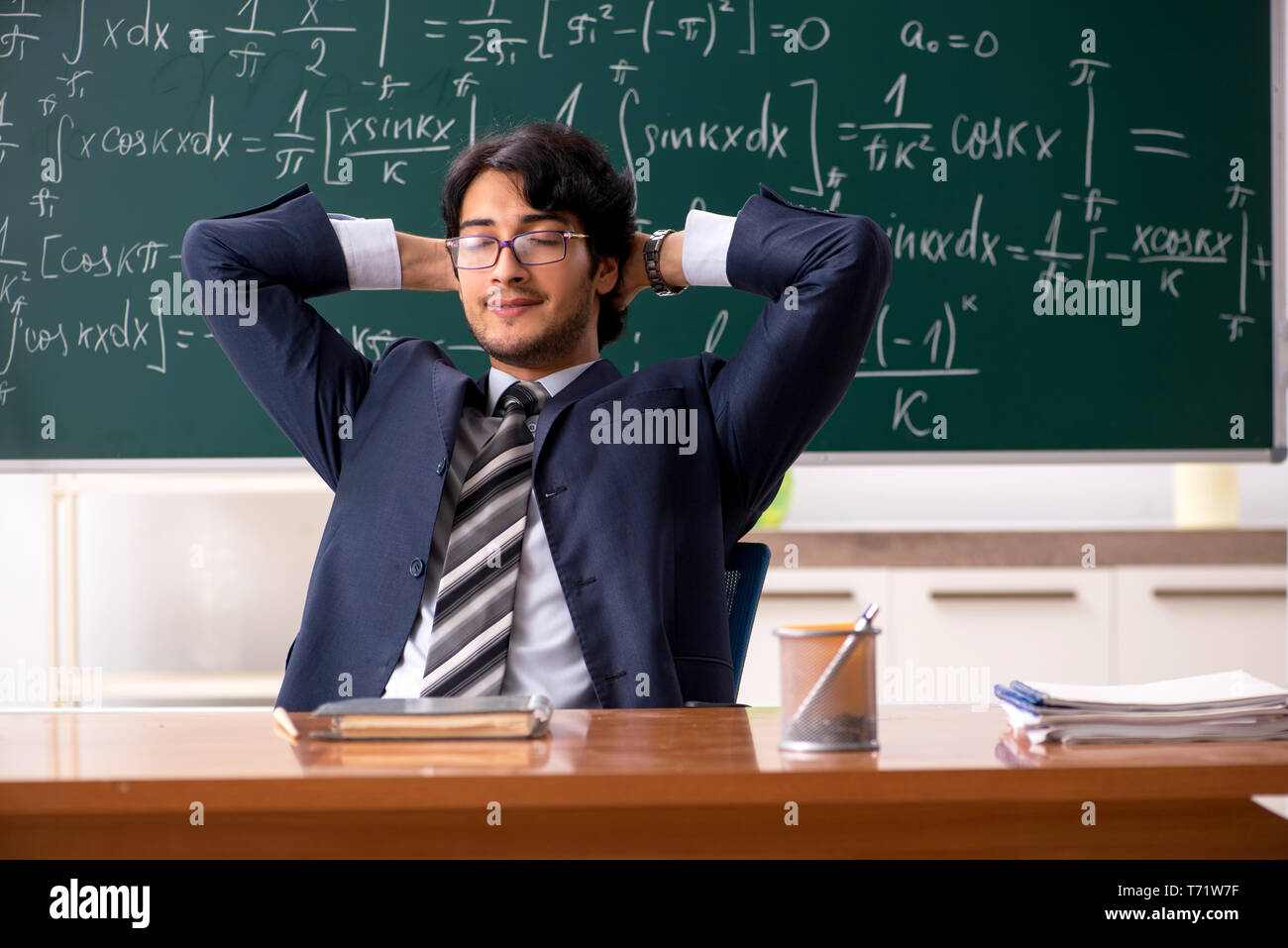 Exhausted teacher in classroom hi-res stock photography and images - Alamy