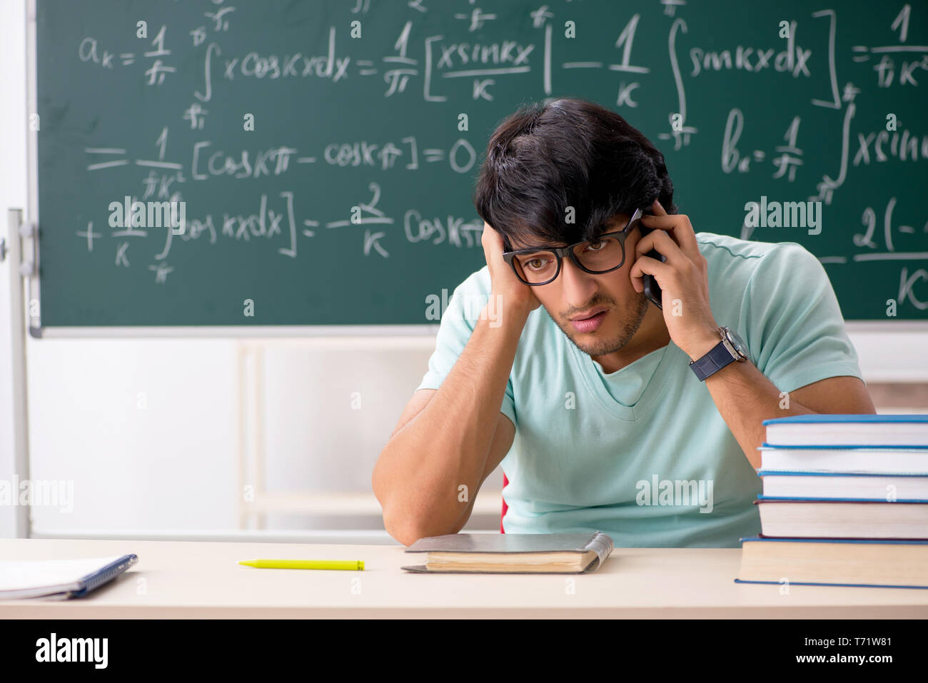 Young male student mathematician in front of chalkboard Stock Photo - Alamy