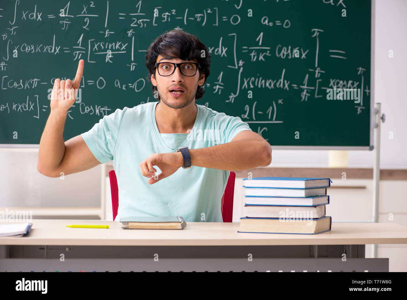 Young male student mathematician in front of chalkboard Stock Photo - Alamy