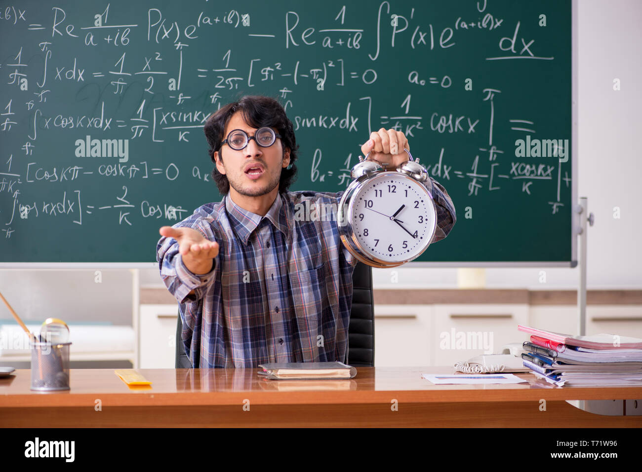 Funny male math teacher in the classroom Stock Photo - Alamy
