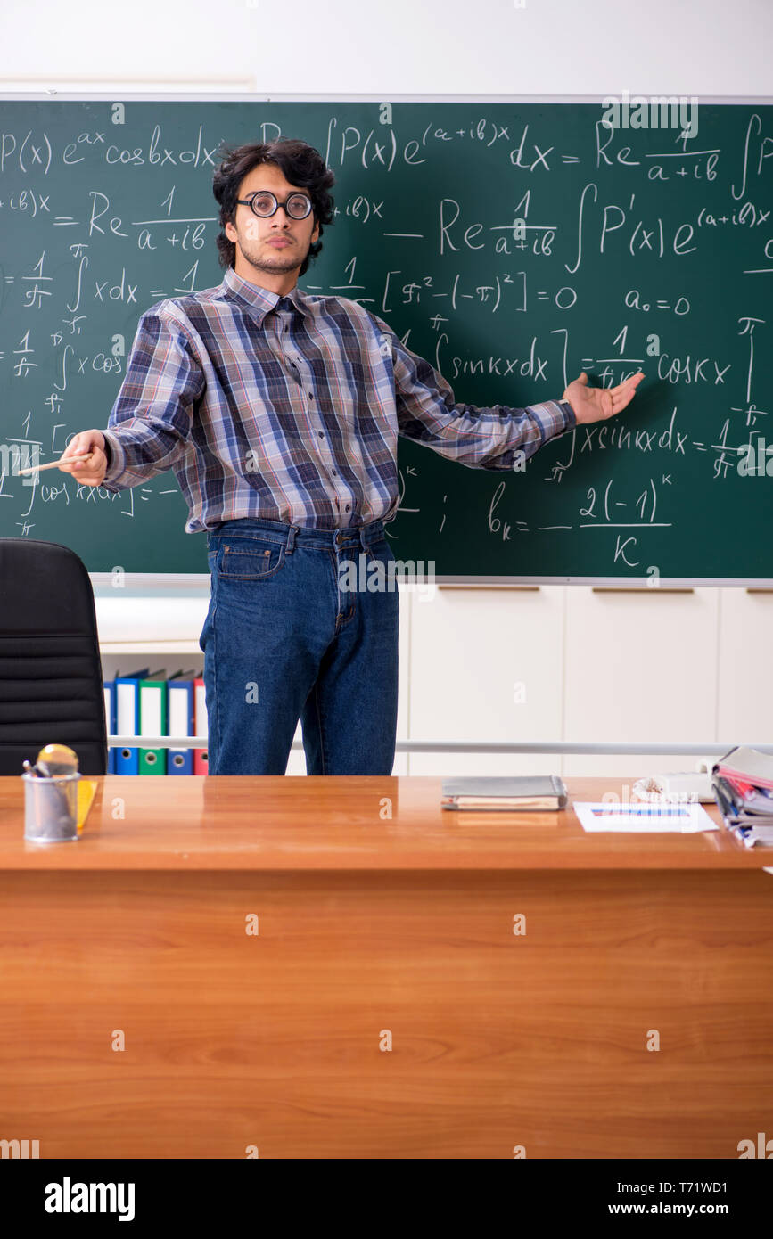 Funny male math teacher in the classroom Stock Photo - Alamy