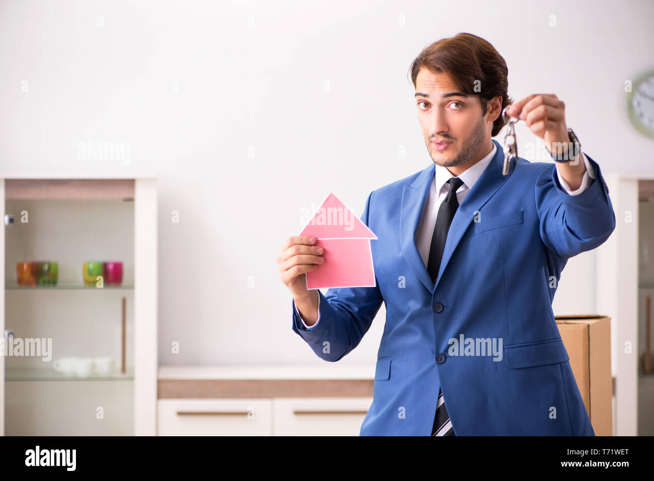 Young handsome realtor selling flat Stock Photo - Alamy