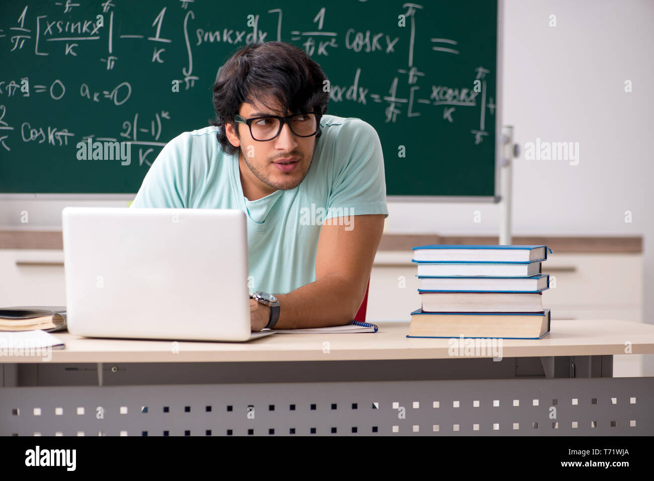 Young male student mathematician in front of chalkboard Stock Photo - Alamy
