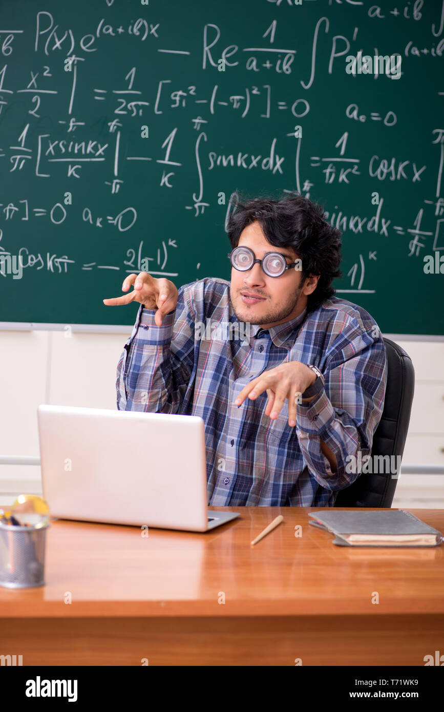Funny male math teacher in the classroom Stock Photo - Alamy