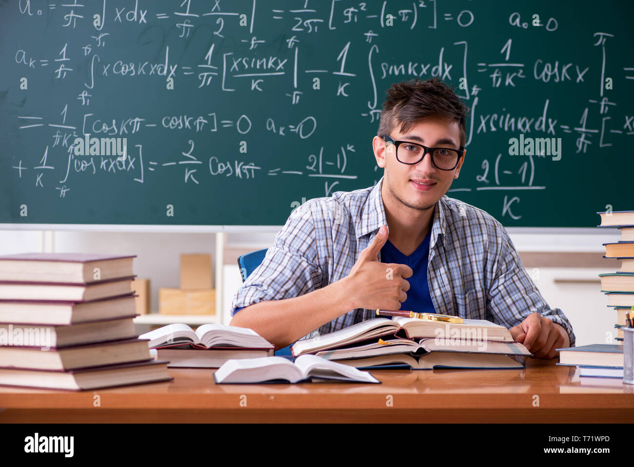 Young male student studying math at school Stock Photo - Alamy