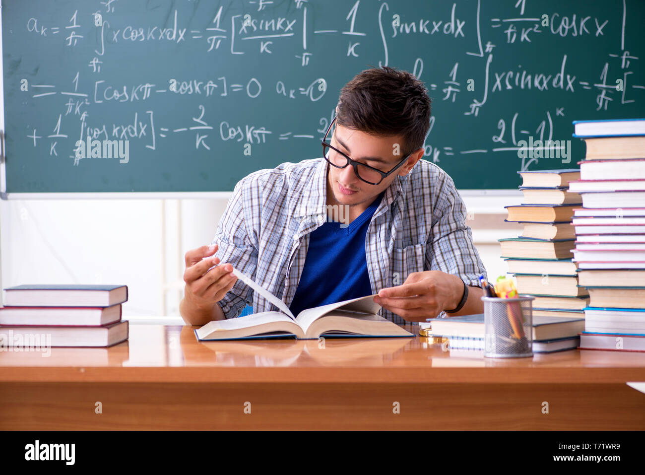Young male student studying math at school Stock Photo - Alamy