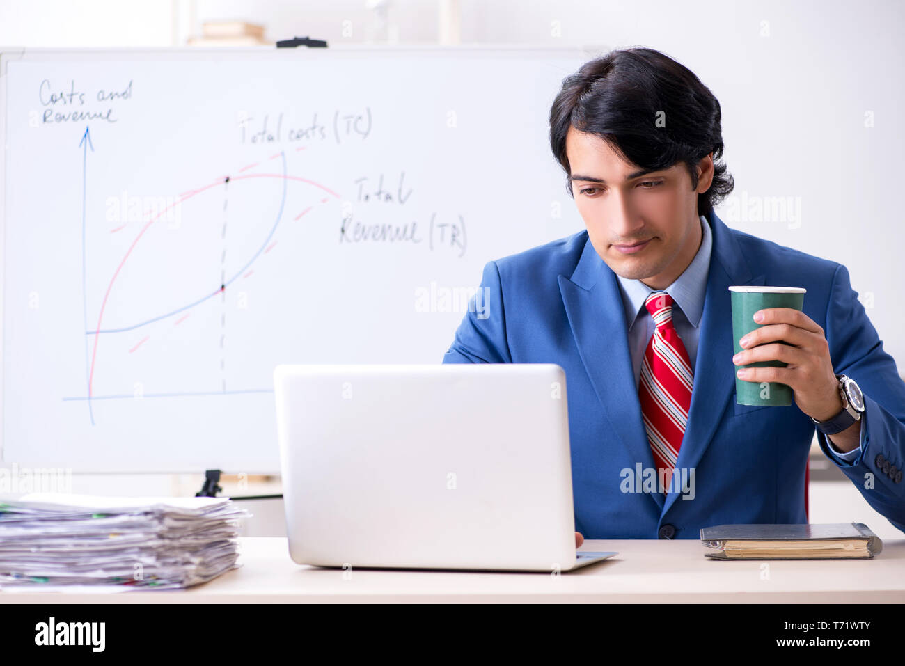 Busy businessman explaining business charts Stock Photo - Alamy