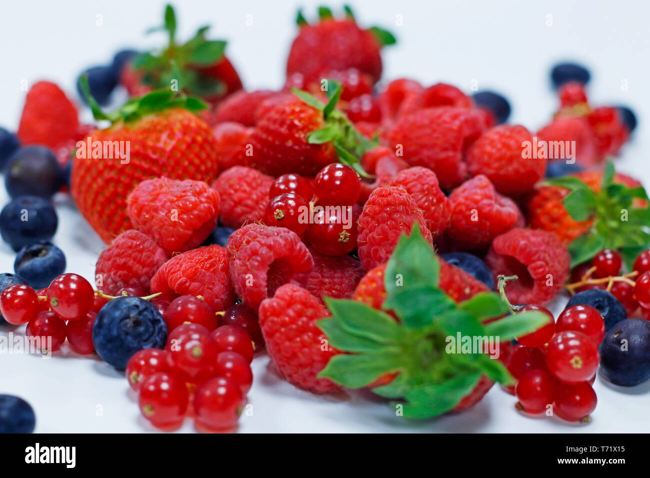 assorted fresh berries with white background Stock Photo - Alamy