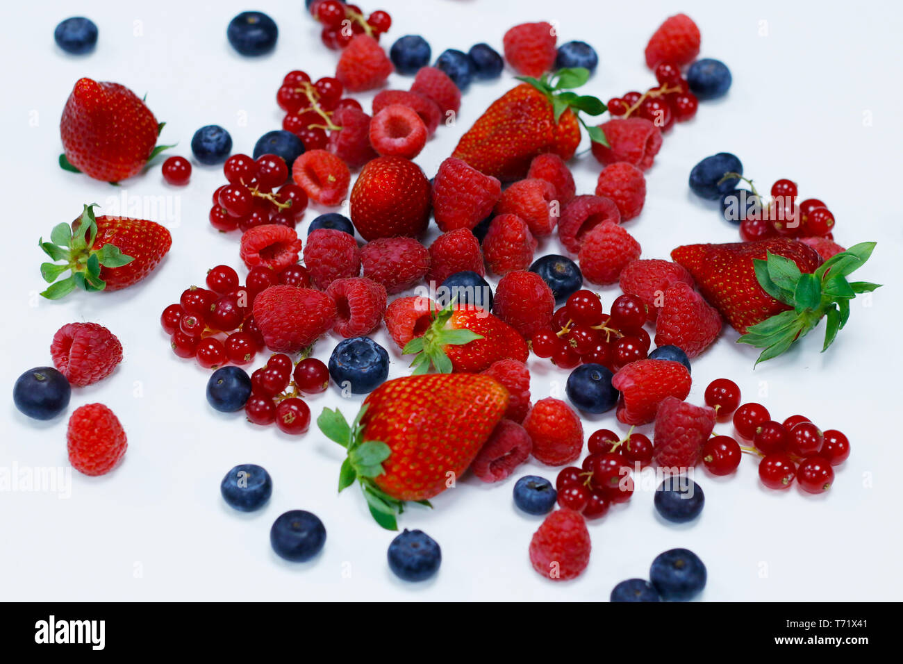 assorted fresh berries with white background Stock Photo - Alamy