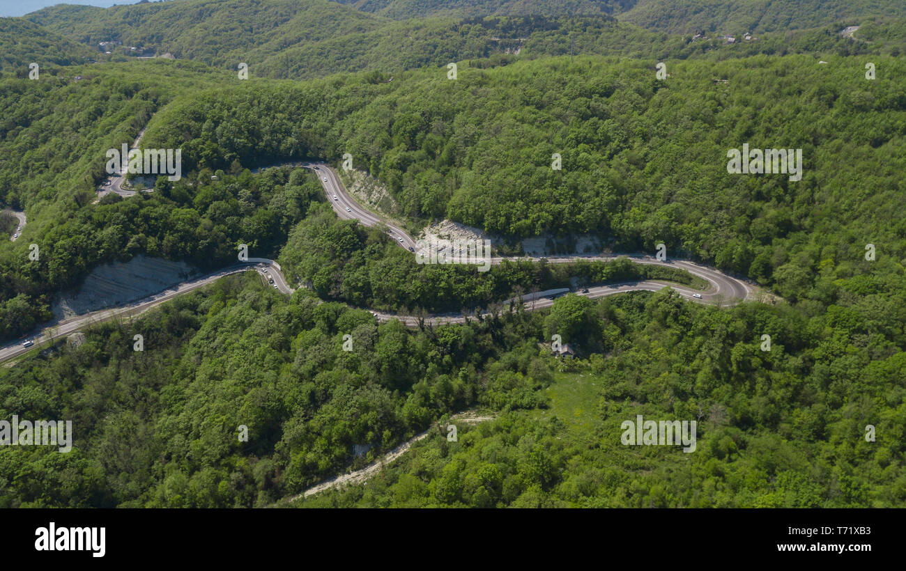 Aerial view of a curved winding road trough the mountains Stock Photo ...