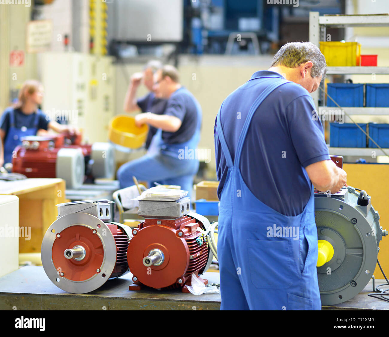 Workers in a factory assemble electric motors Stock Photo - Alamy