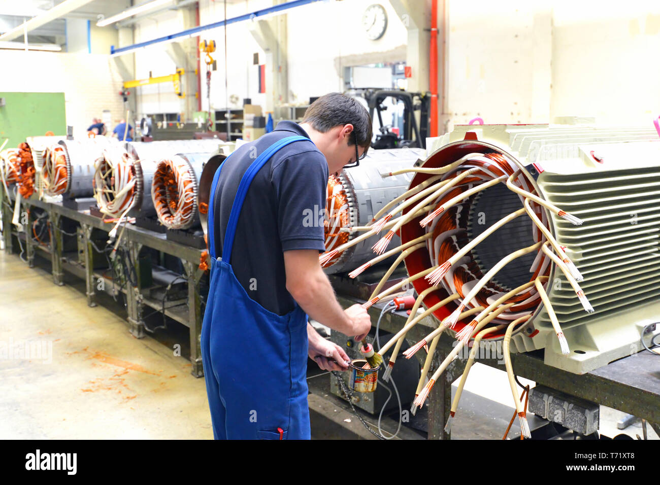 Workers in a factory assemble electric motors Stock Photo - Alamy