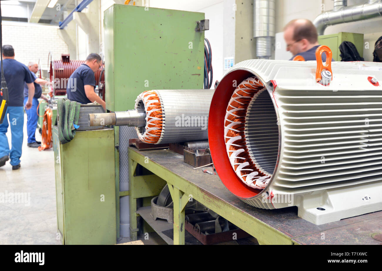 Workers in a factory assemble electric motors Stock Photo - Alamy