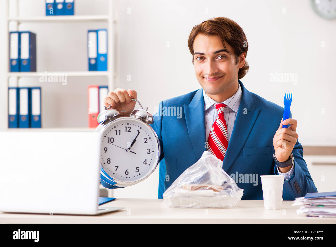 Man having meal at work during break Stock Photo - Alamy