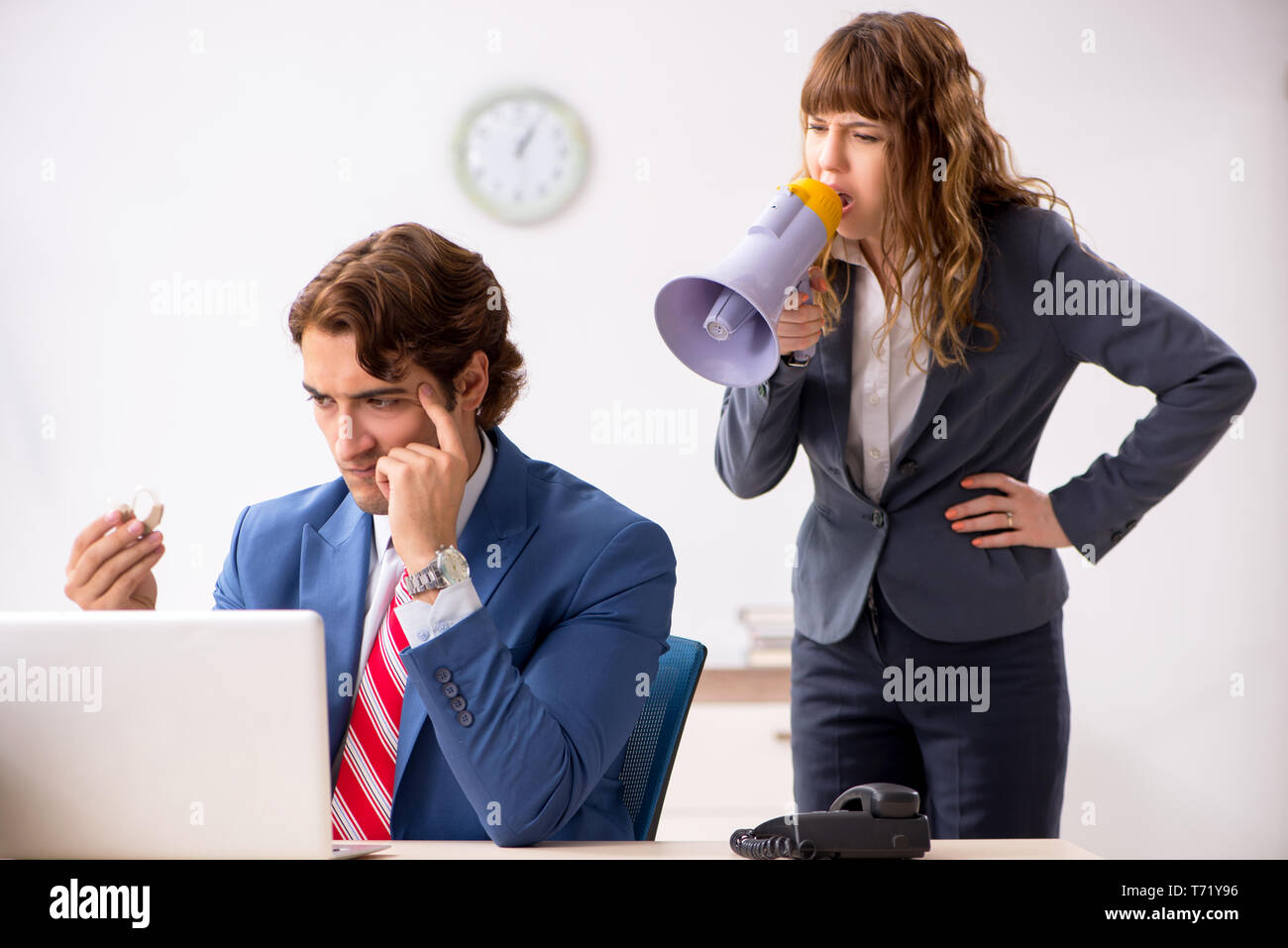 Deaf employee using hearing aid talking to boss Stock Photo - Alamy
