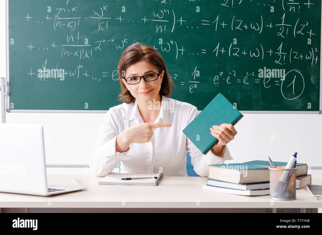 Female math teacher in front of the chalkboard Stock Photo - Alamy