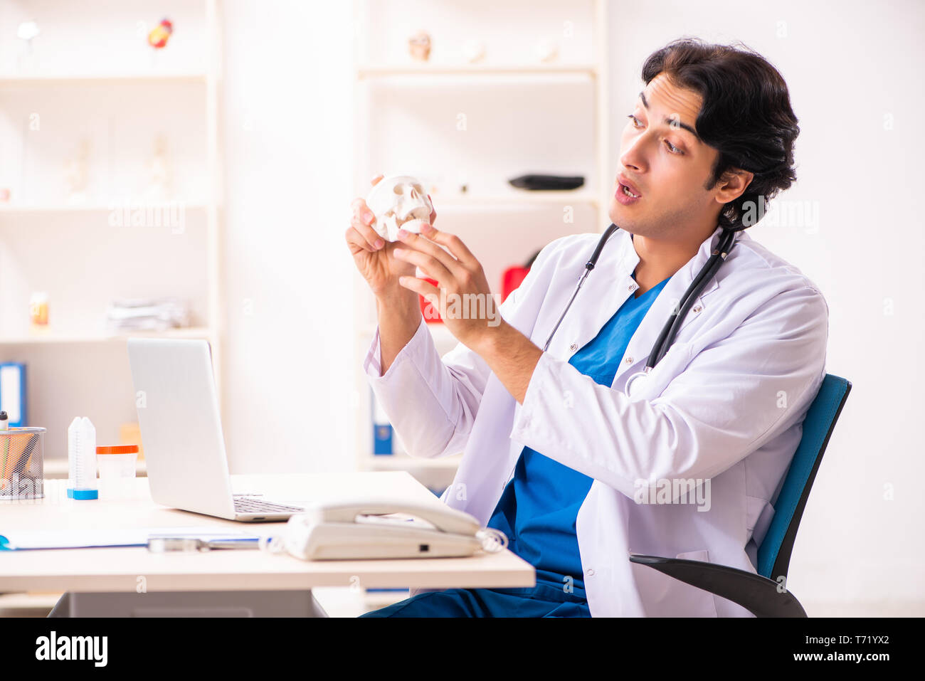 Young male doctor with human's skull Stock Photo - Alamy