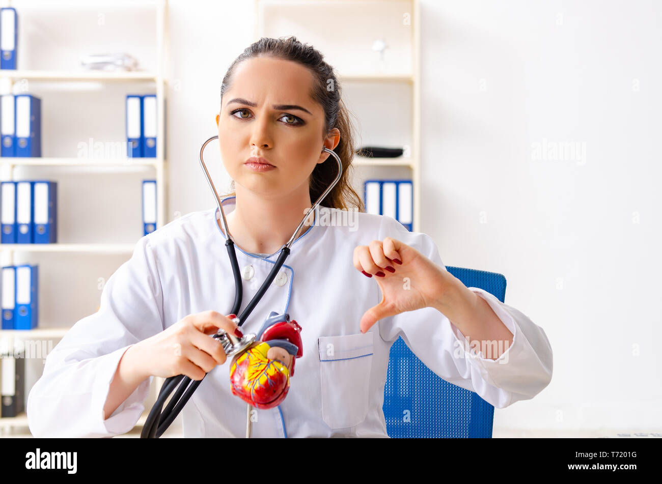 Young female doctor cardiologist sitting at the hospital Stock Photo ...