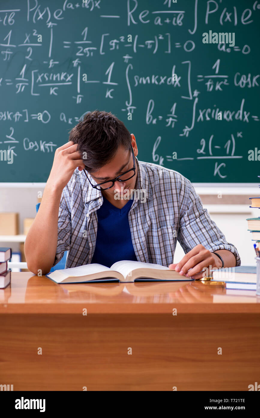 Young male student studying math at school Stock Photo - Alamy