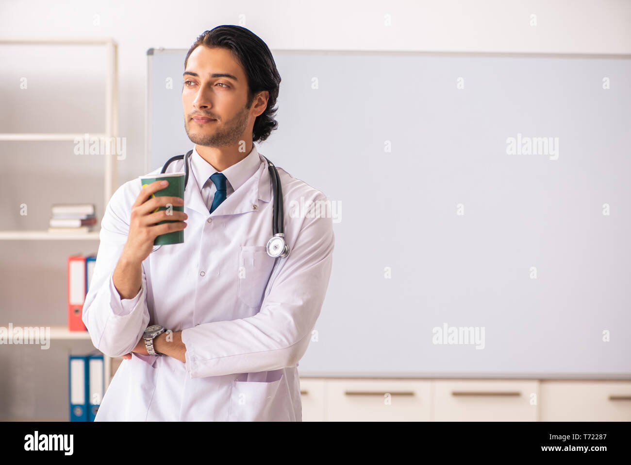 Young doctor drinking coffee in hi-res stock photography and images - Alamy