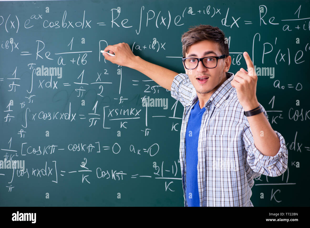 Young male student studying math at school Stock Photo - Alamy