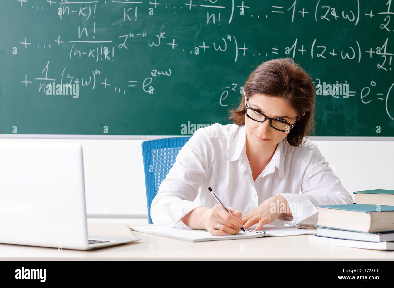 Female math teacher in front of the chalkboard Stock Photo - Alamy