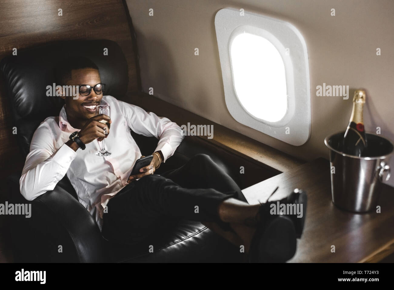 Successful young Afro American black businessman sitting in the chair ...
