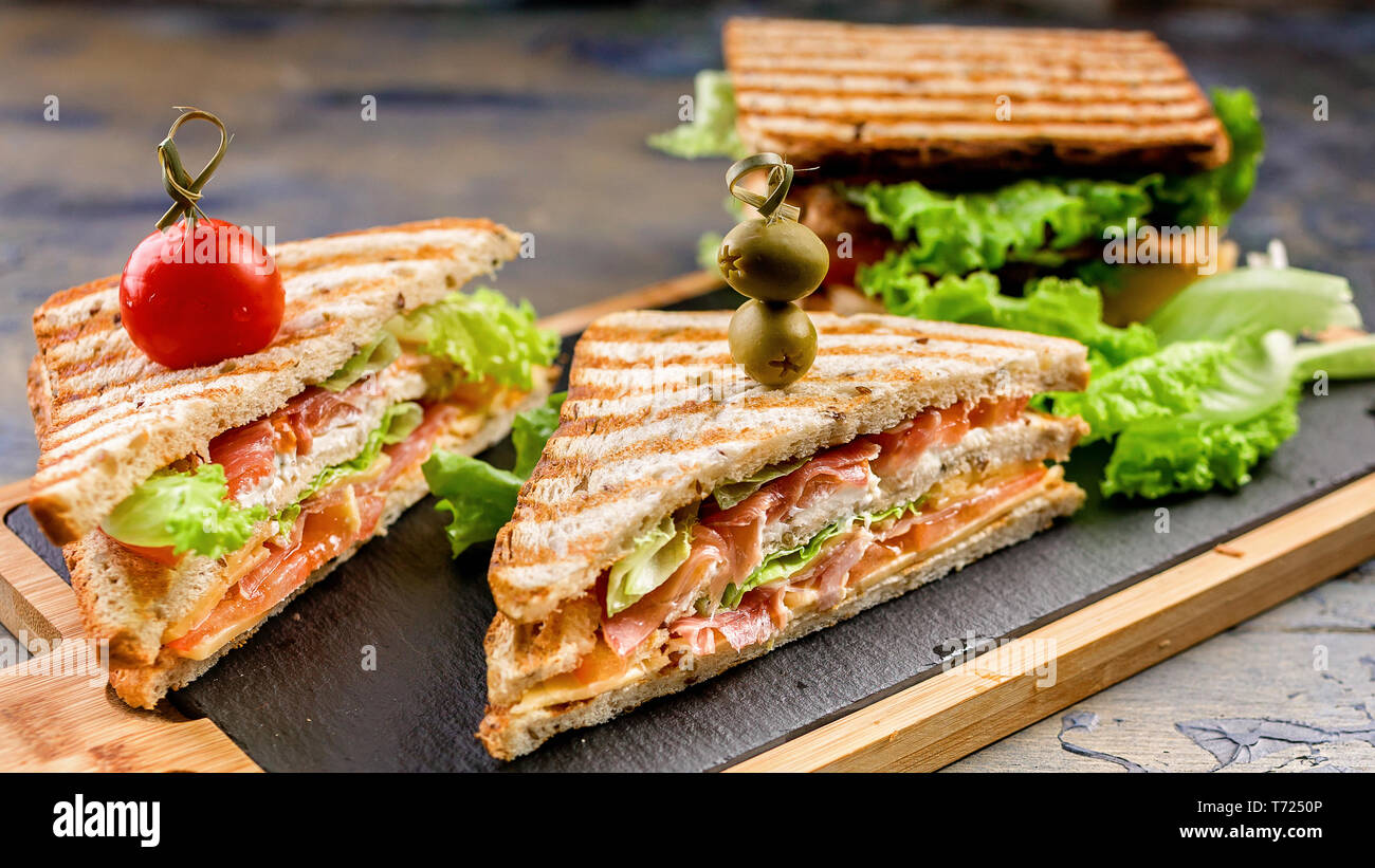Classic toast sandwich with smoked beef, cheese, tomatoes and lettuce ...