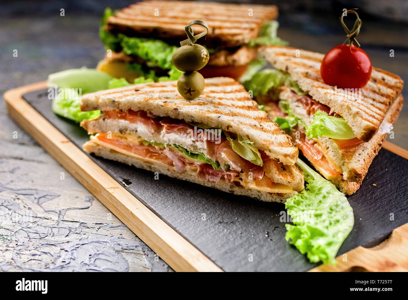 Classic toast sandwich with smoked beef, cheese, tomatoes and lettuce ...