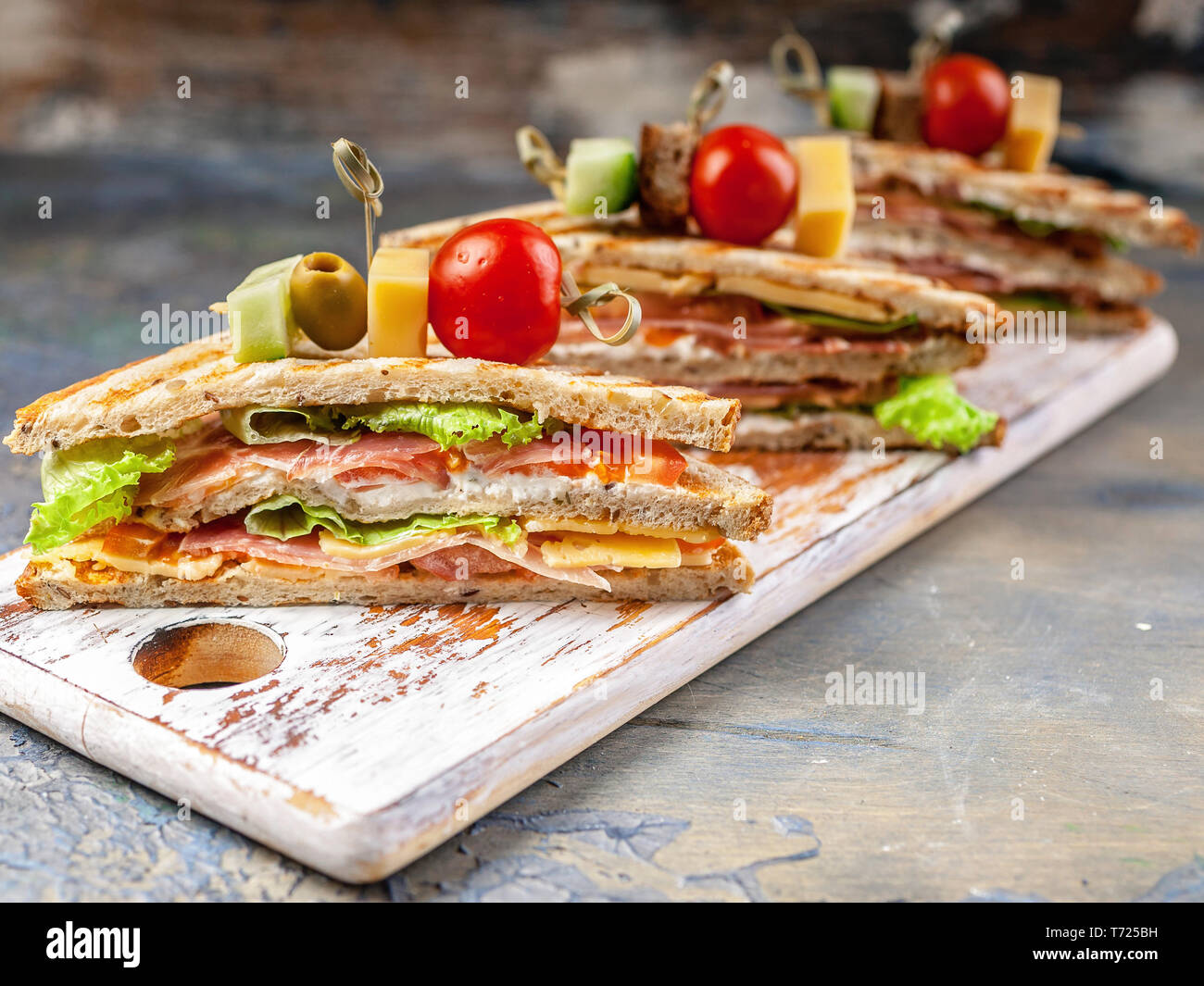 Close Up fresh slice sandwiches with beef, tomatoes and green salad ...