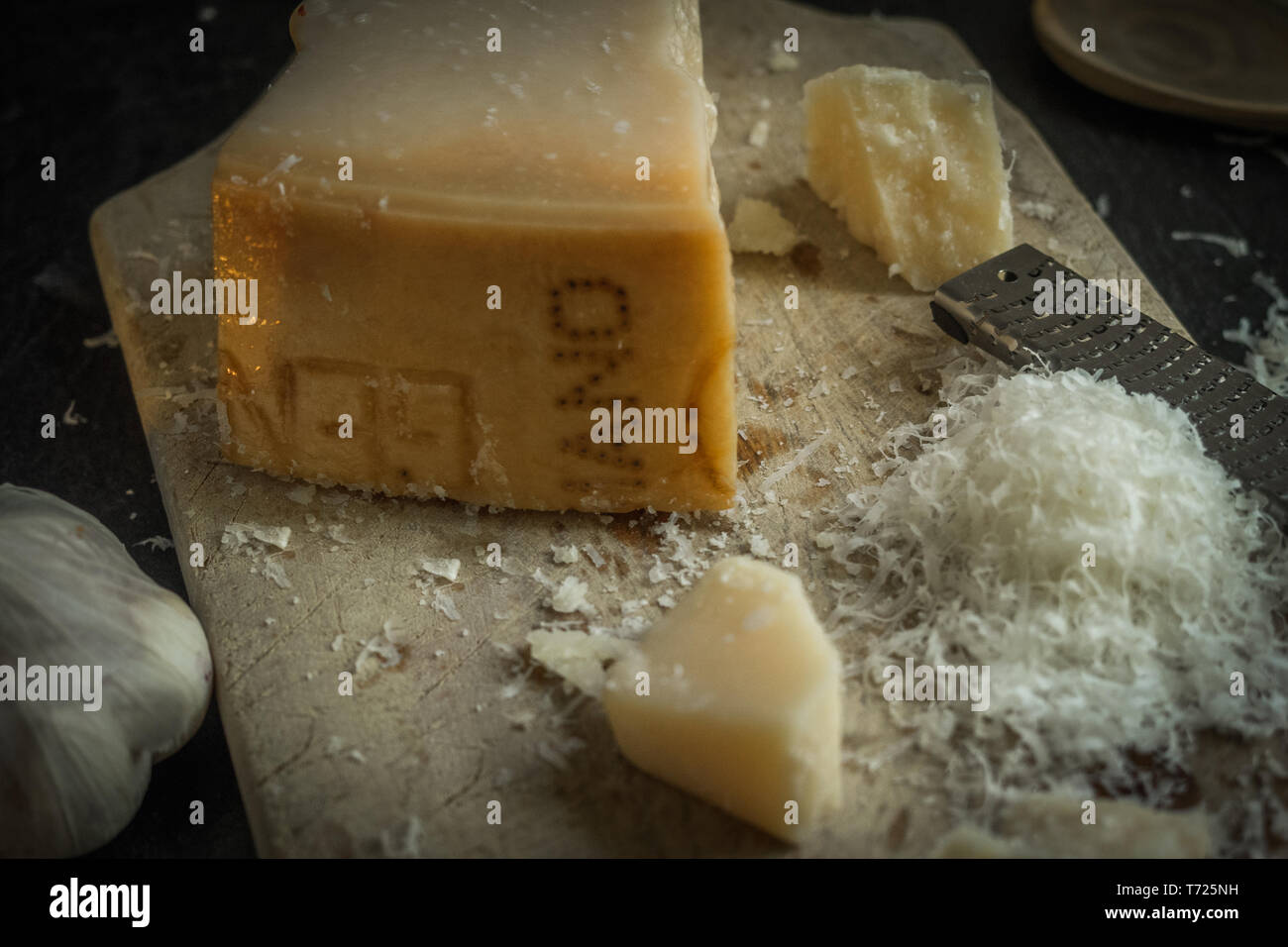Grated parmesan cheese on black background, italian food. Dark food ...