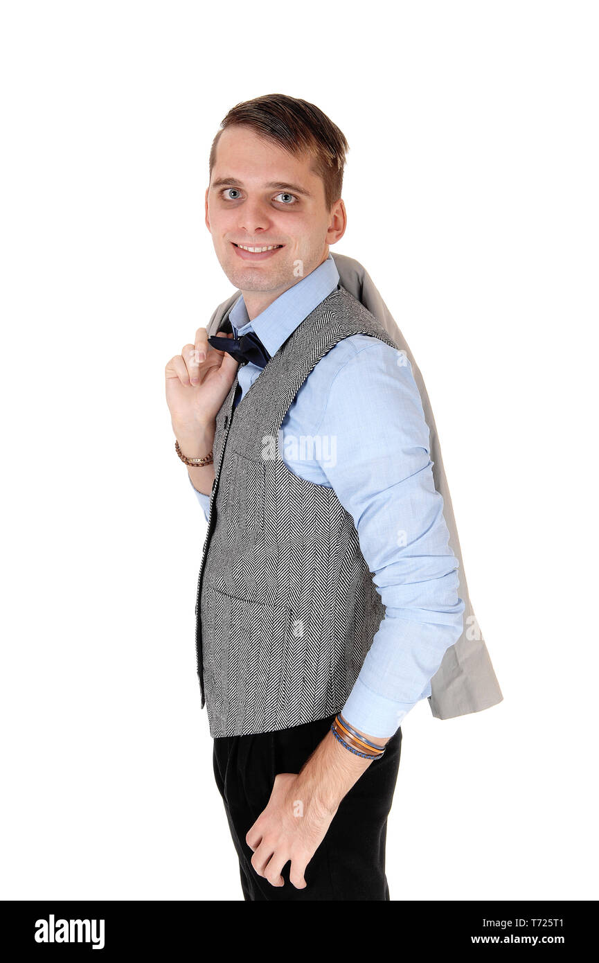 Young man standing whit his jacket over shoulder Stock Photo - Alamy