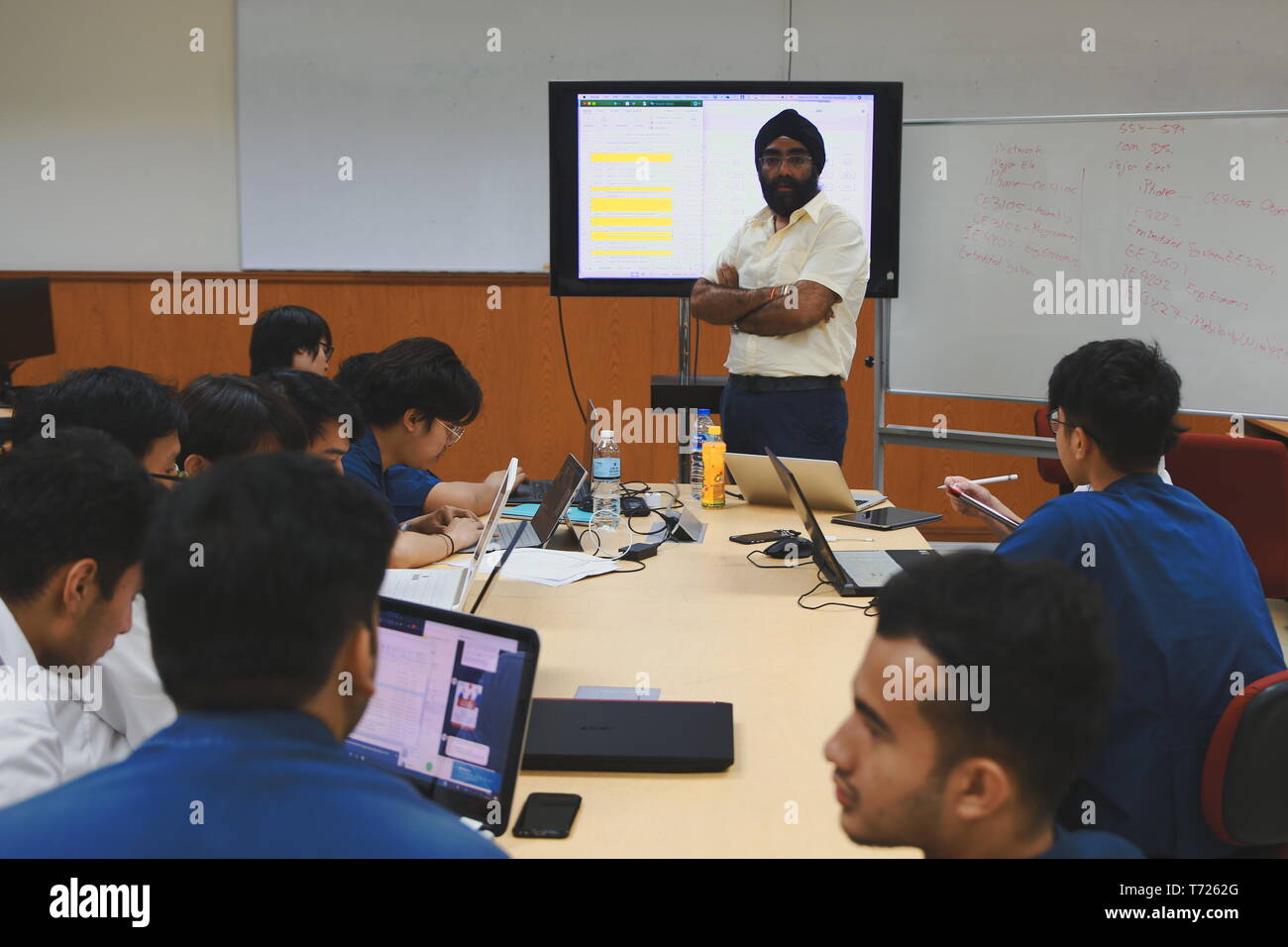 Lecturer at Assumption University (ABAC) teaching a group of computer ...