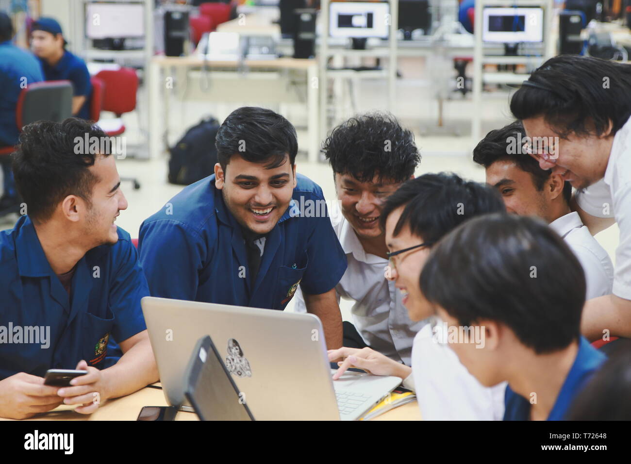 Group of Asian computer engineering students working together to ...