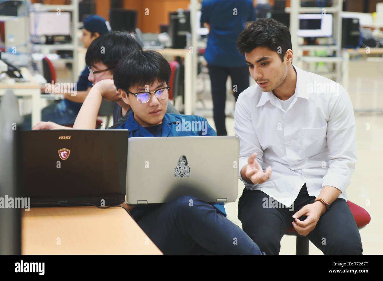 Group of Asian computer engineering students working together and ...