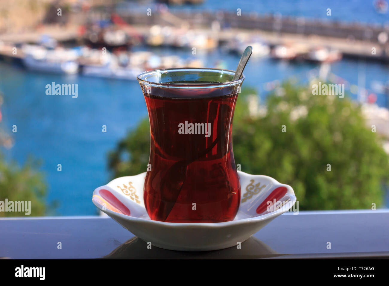 Turkish black tea in traditional glass on background of the blue ...