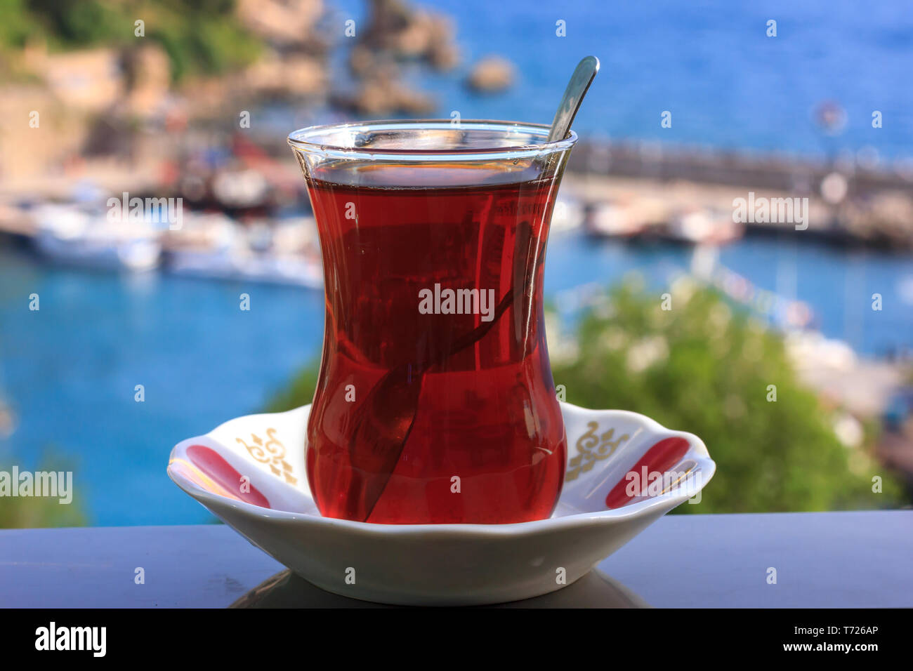 Turkish black tea in traditional glass on background of the blue ...