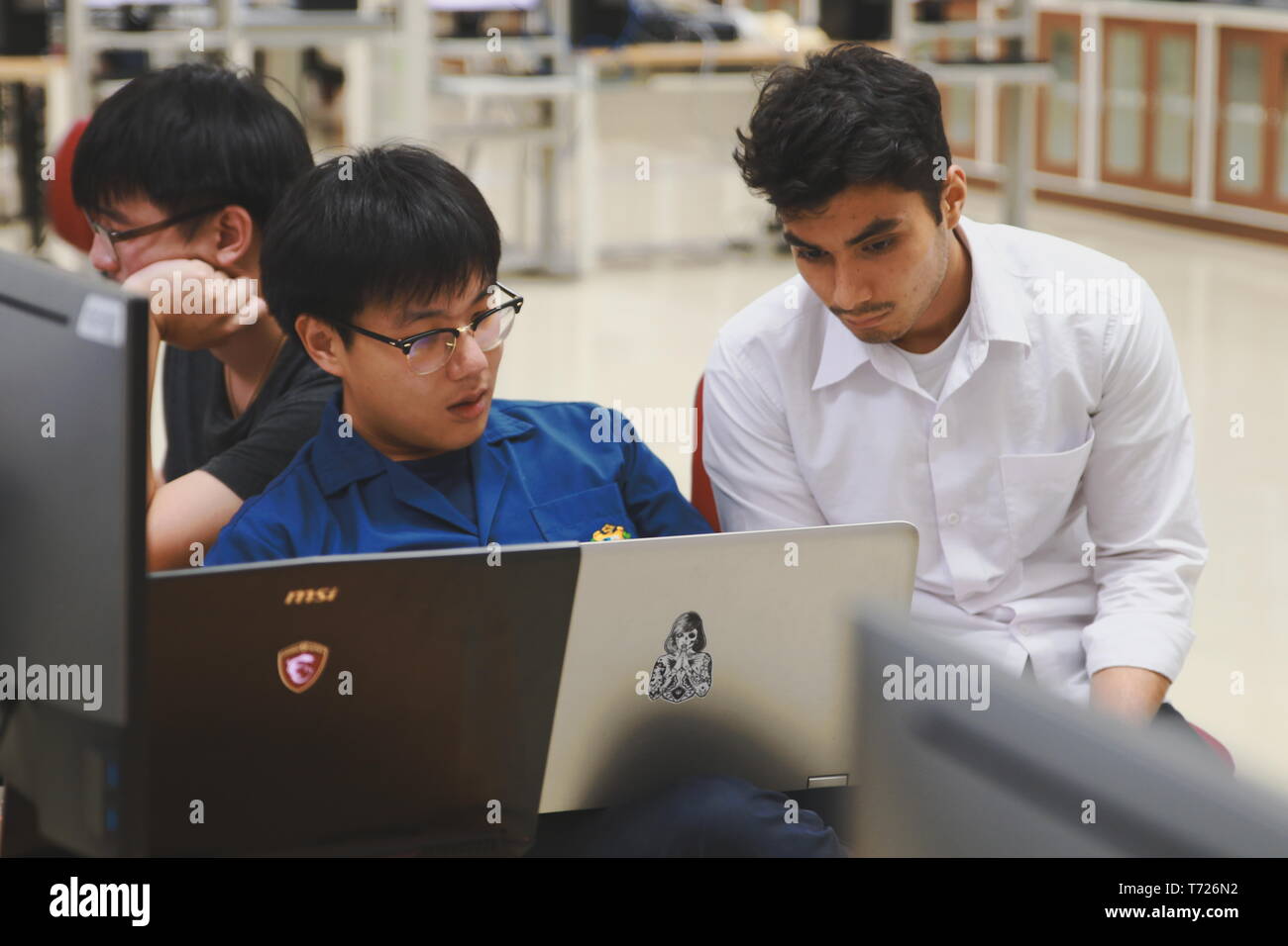 Group of Asian computer engineering students working together and ...