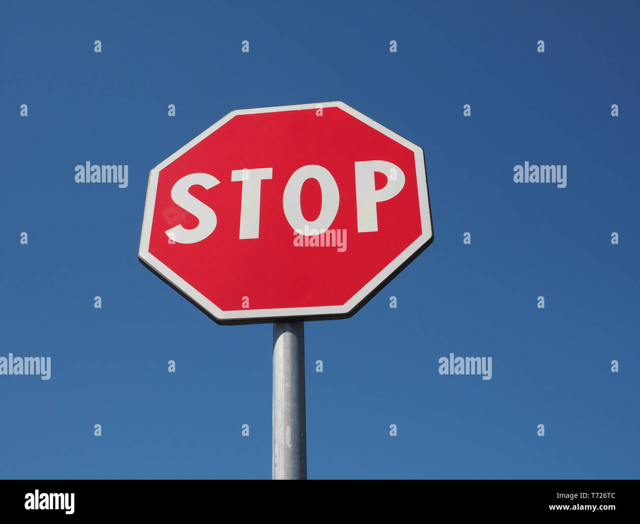 Warning signs, stop traffic sign over blue sky Stock Photo - Alamy
