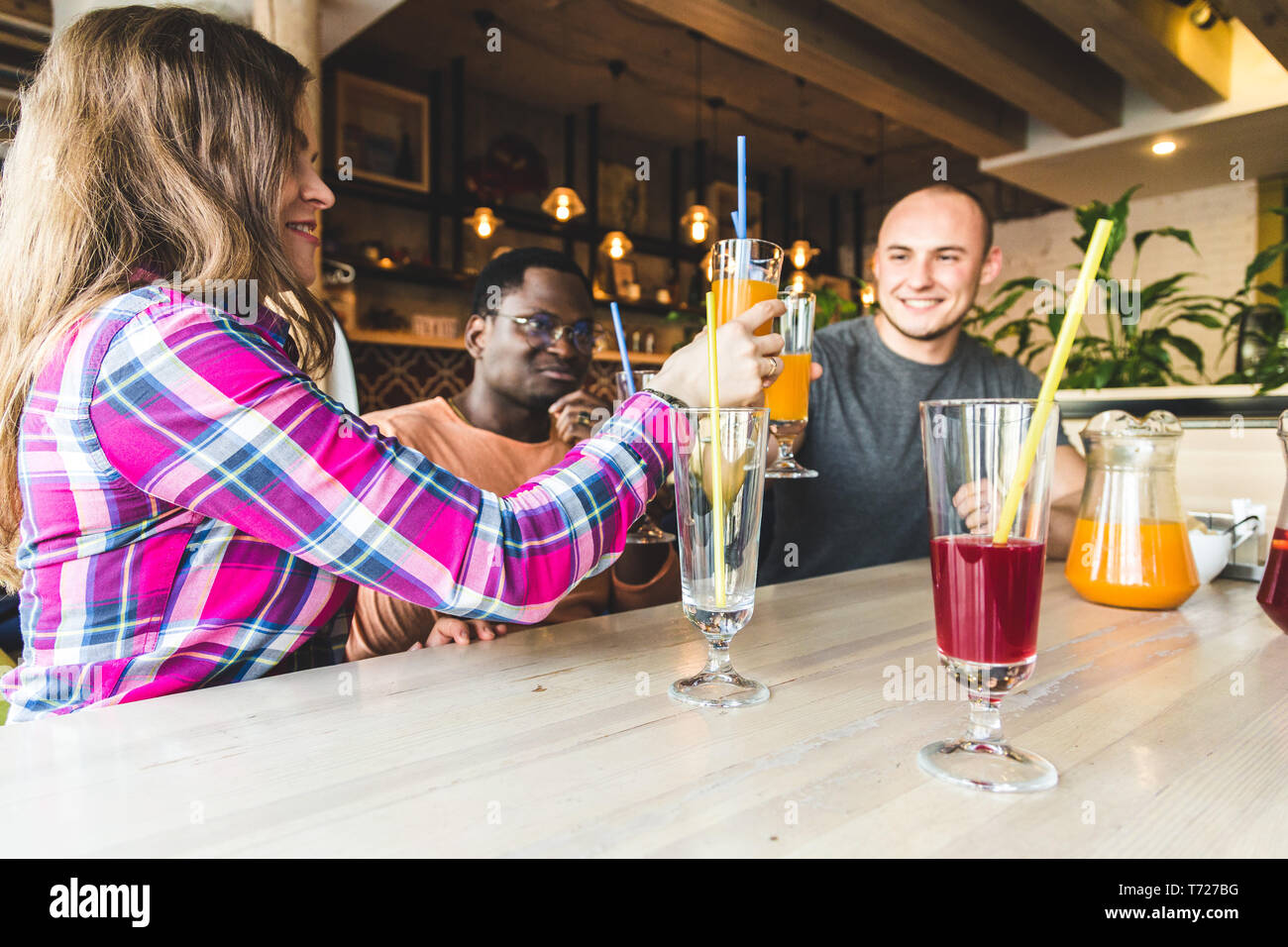 A company of young people having fun, drinking drinks, cocktails ...