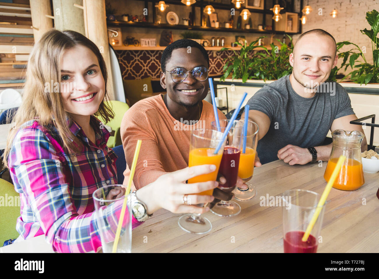 A company of young people having fun, drinking drinks, cocktails ...