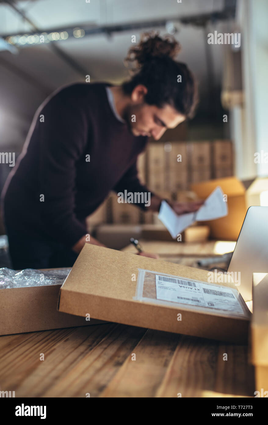Parcel box on desk with man making notes in the back. Businessman ...
