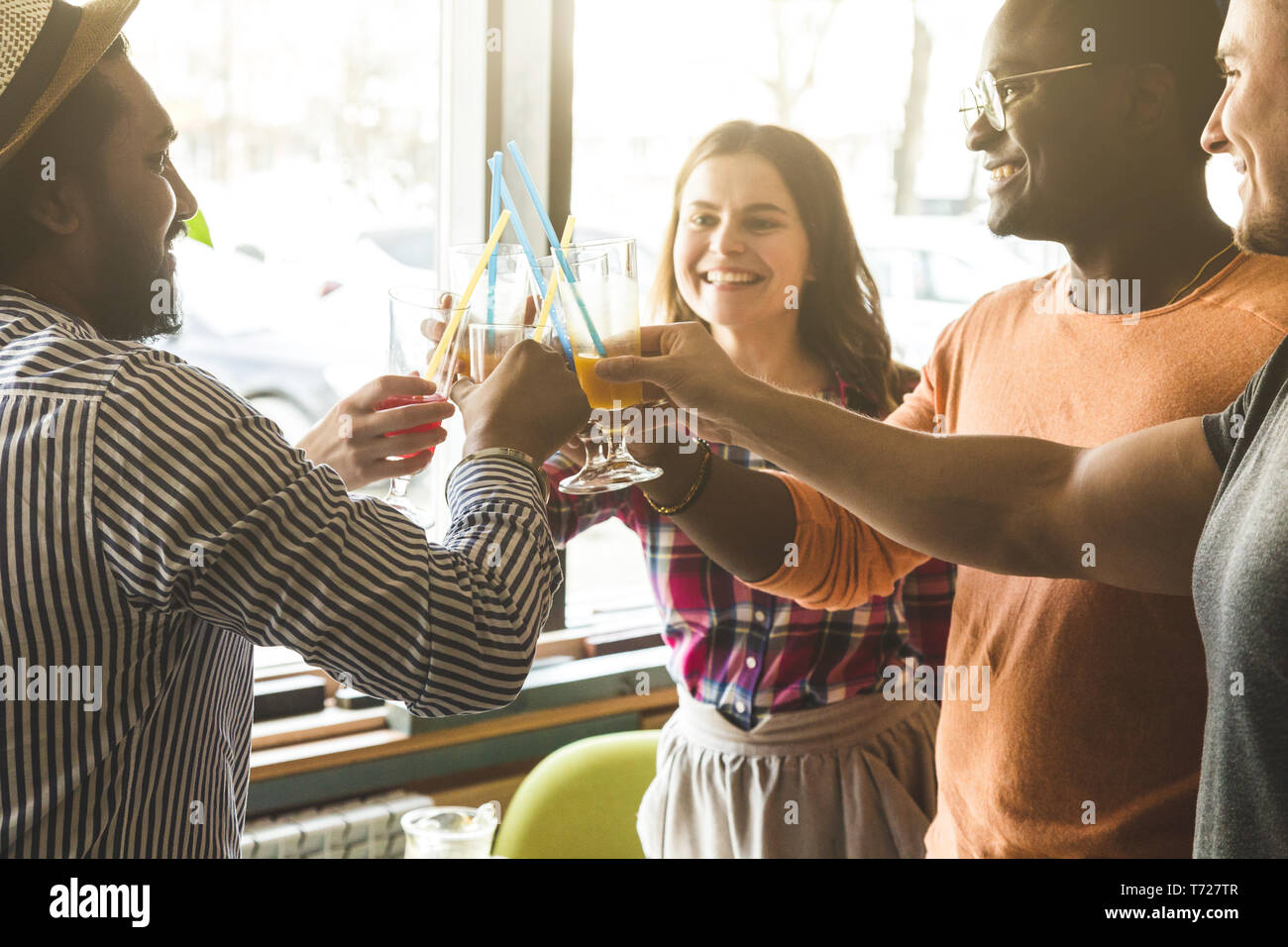 Meet young attractive people in the cafe. Friends chat, have fun, drink ...