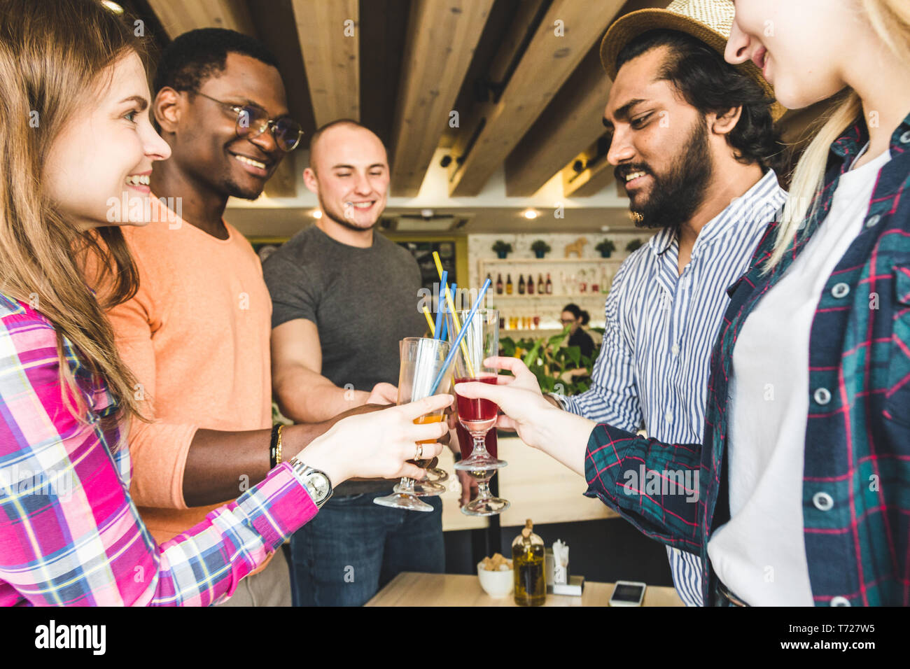 Meet young attractive people in the cafe. Friends chat, have fun, drink ...