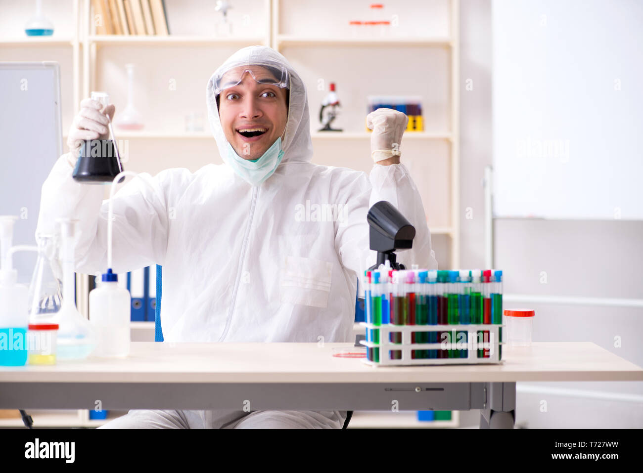 Young handsome chemist working in the lab Stock Photo - Alamy
